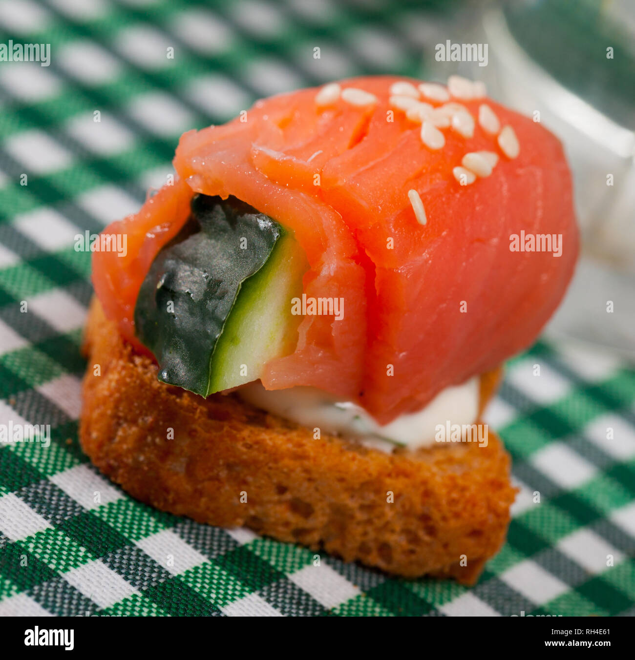 Delicious canape on toasted bread with smoked salmon, cucumber and ...