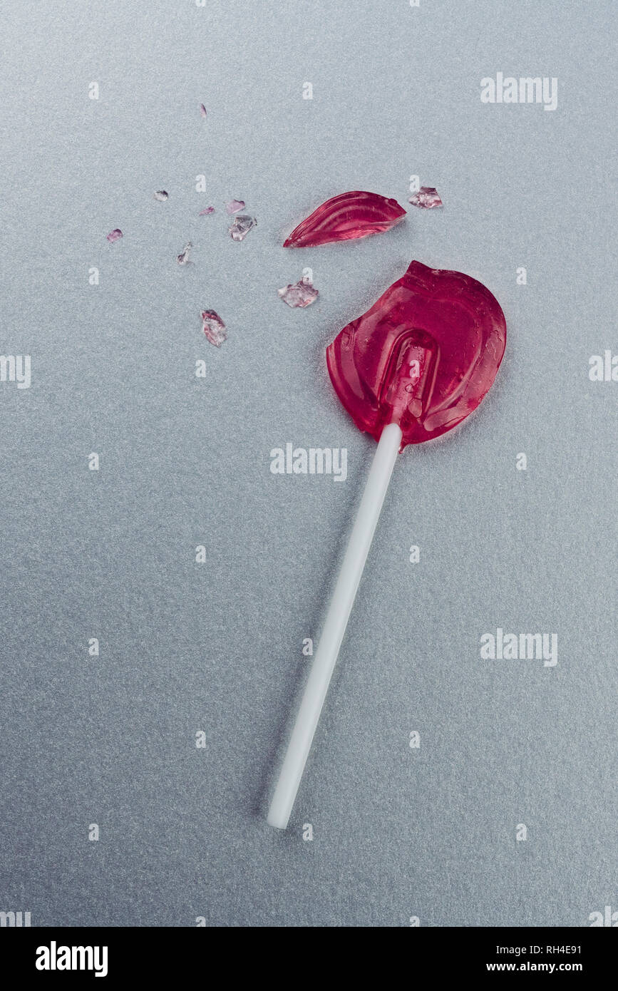 Broken heart-shape lollipop Stock Photo - Alamy
