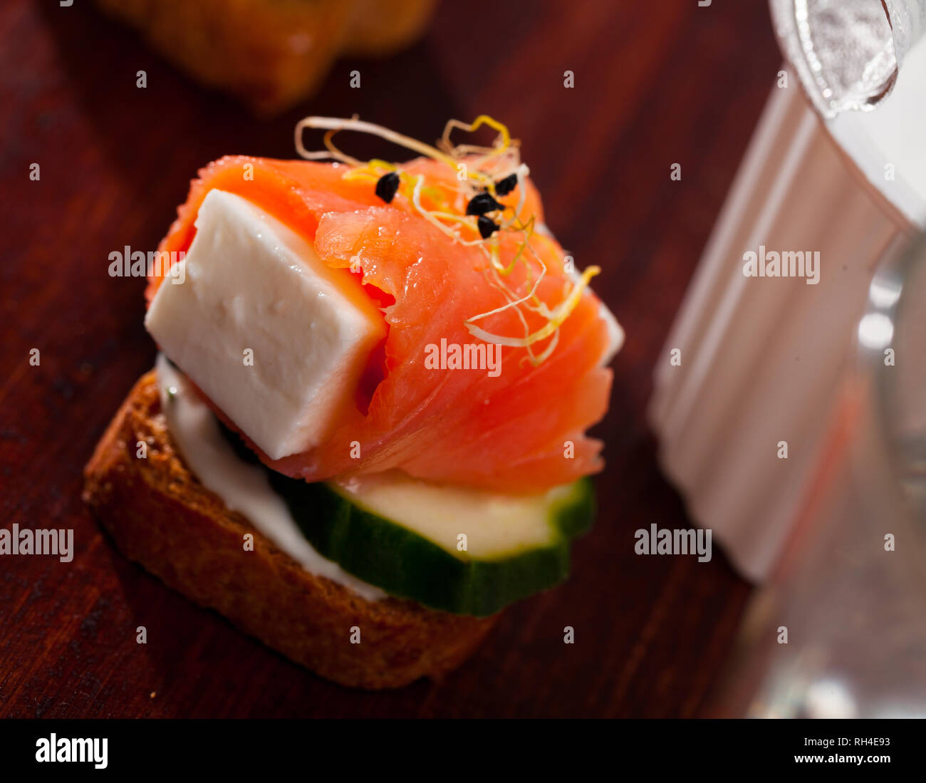 Delicious canape on toasted bread with smoked salmon, young cheese ...