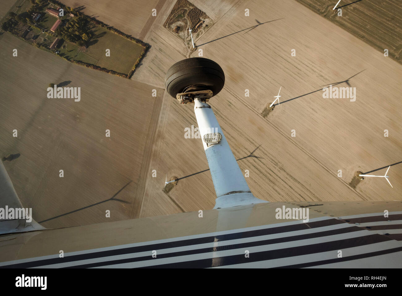 Aerial view from airplane of wind turbines in rural field, Brandenburg ...