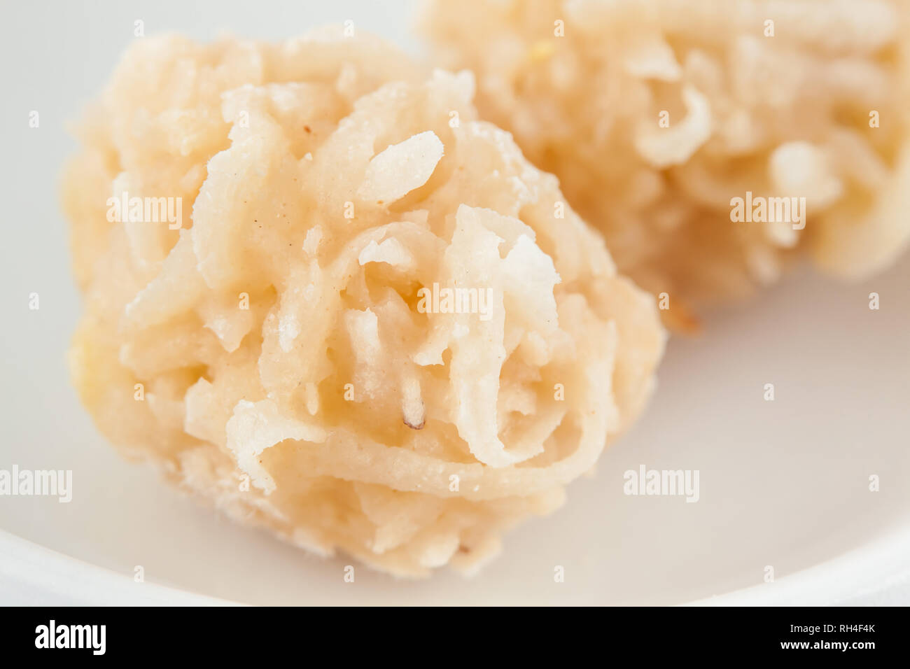 Colombian traditional coconut sweet called cocada in a white ceramic ...