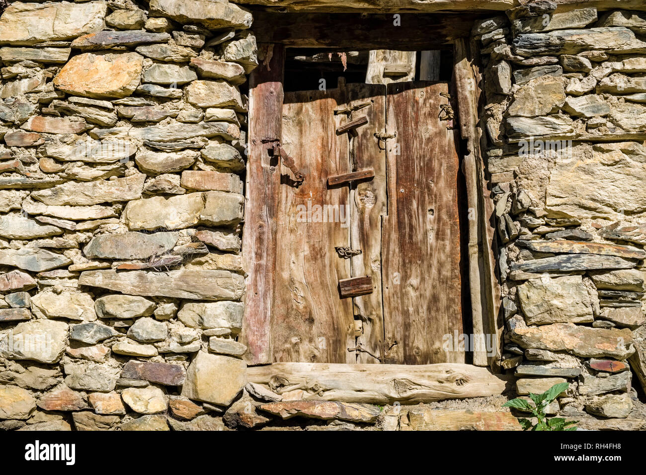 Wooden door of a traditional stone house of the village in the upper ...