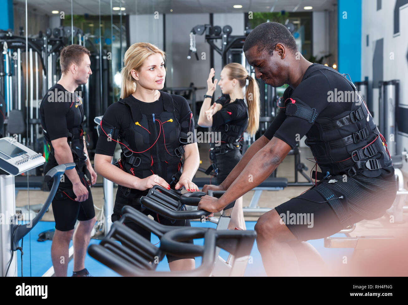 Joyful people in top shape taking break during workout at gym Stock ...