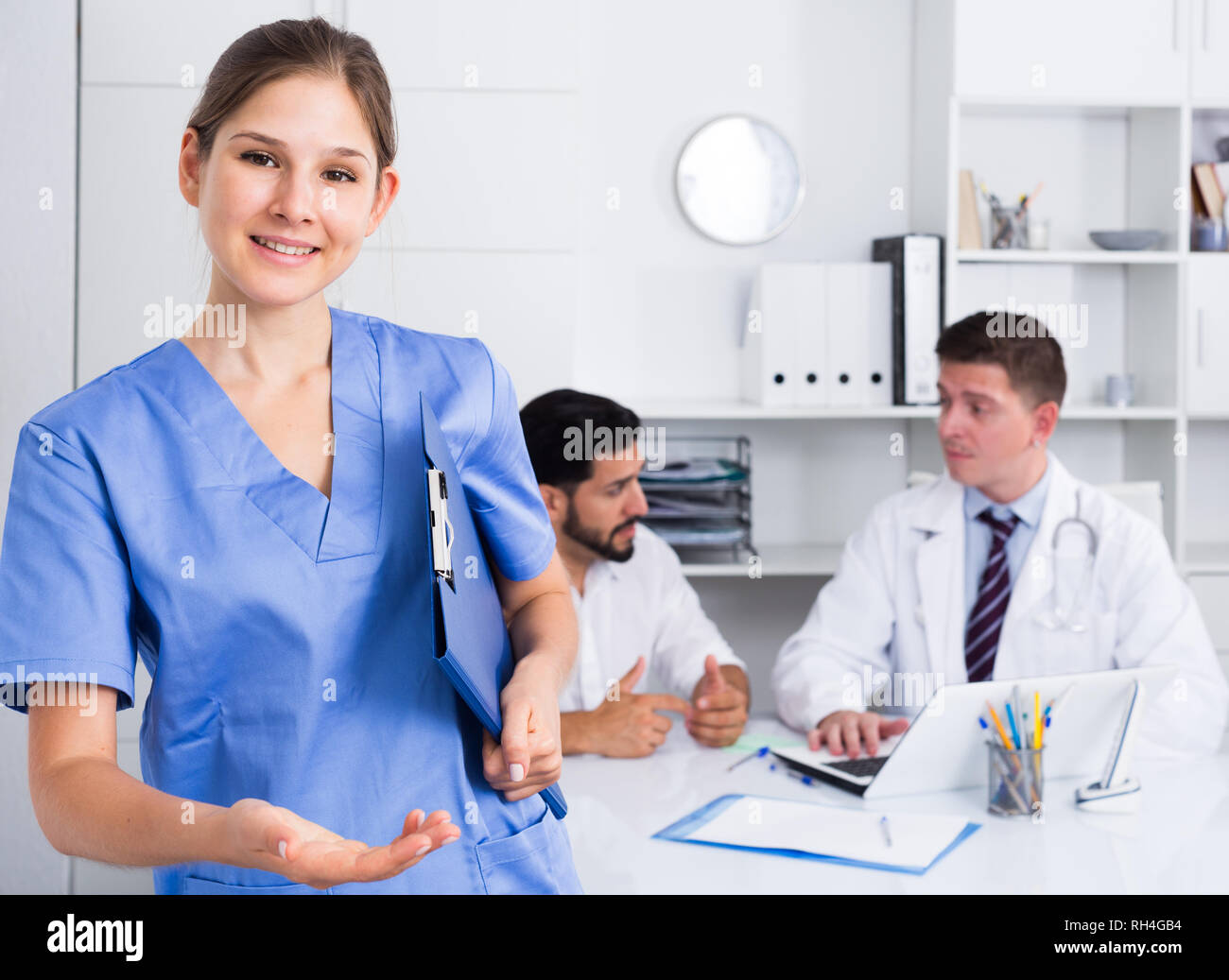 Female doctor making welcome gesture, politely inviting patient in ...