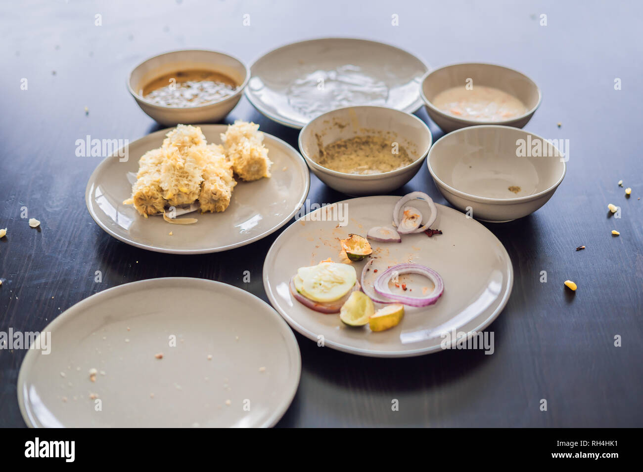 Plates with crumbs of food. Remains of food in plates after lunch or ...