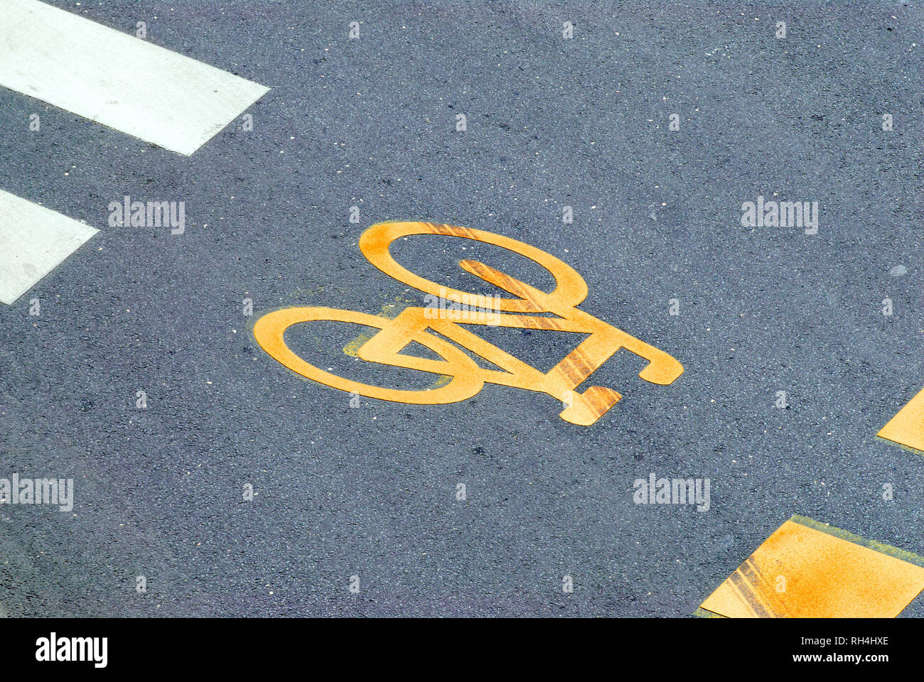Bicycle lane marking yellow sign on asphalt Stock Photo - Alamy