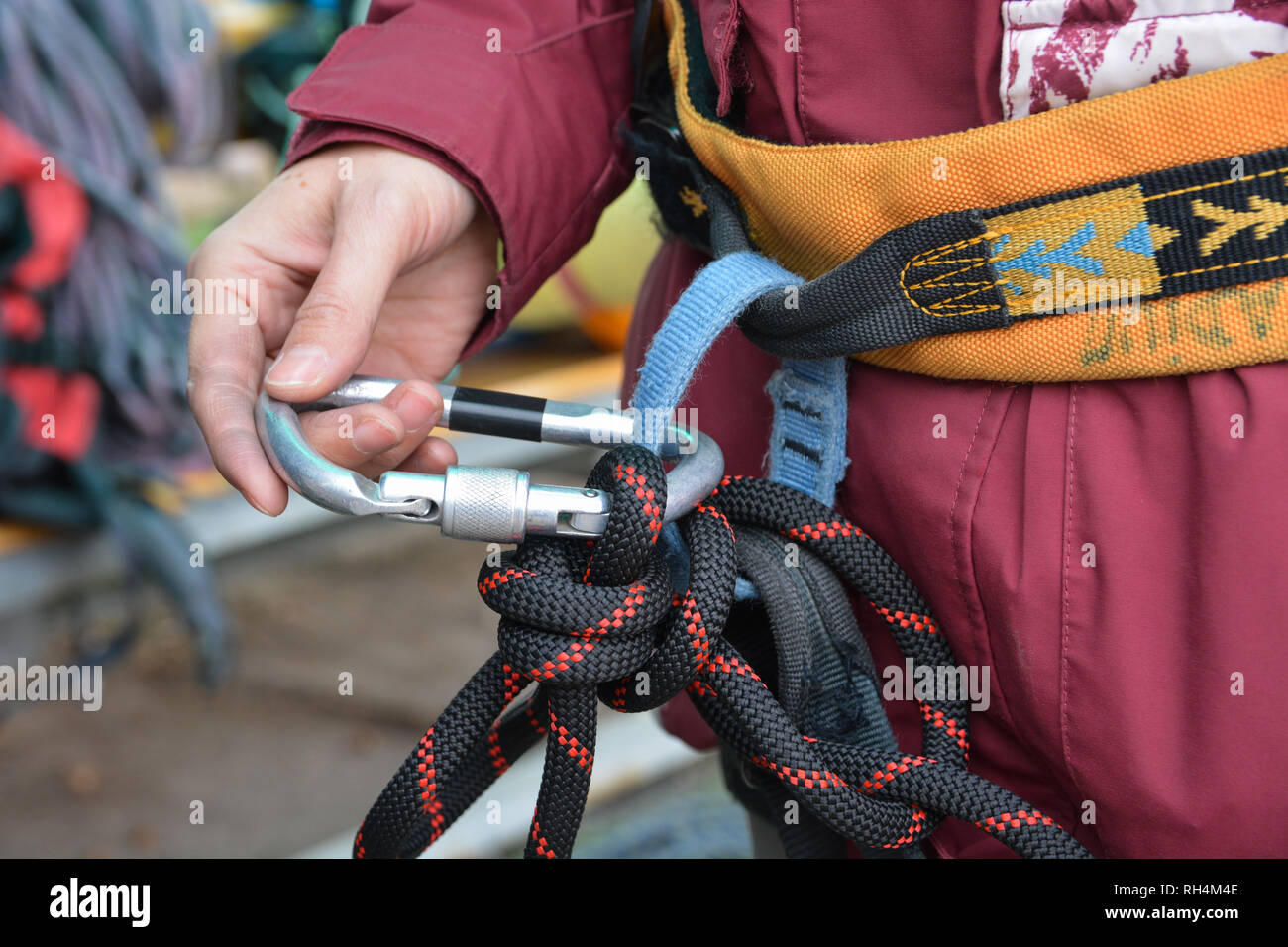 Close up hand of climber, alpinist, is adjusting climbing gear ...