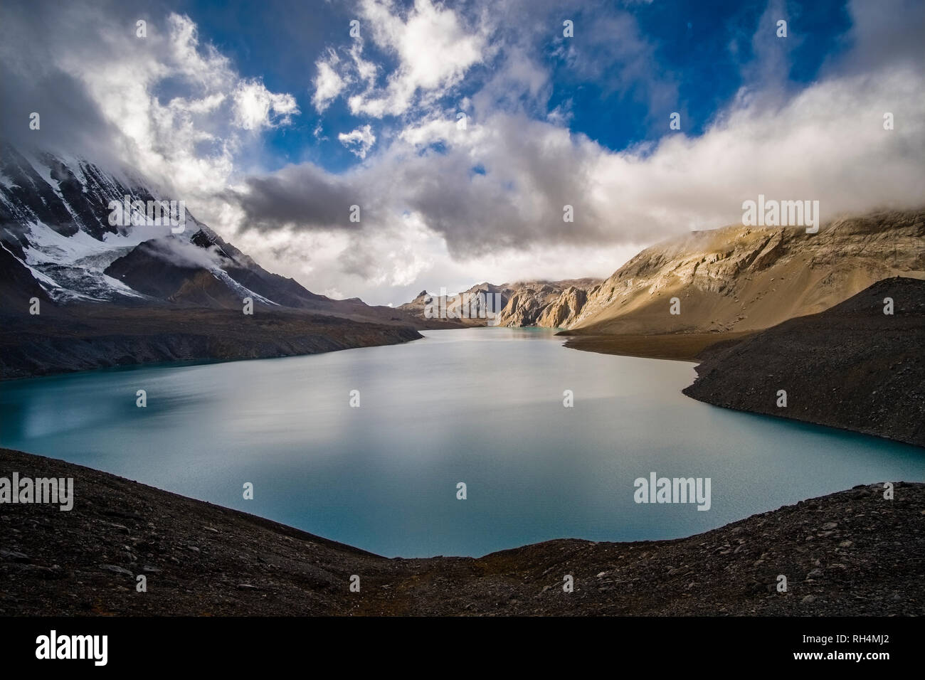 Panoramic view on Tilicho Lake, the snow covered slopes of Tilicho Peak ...