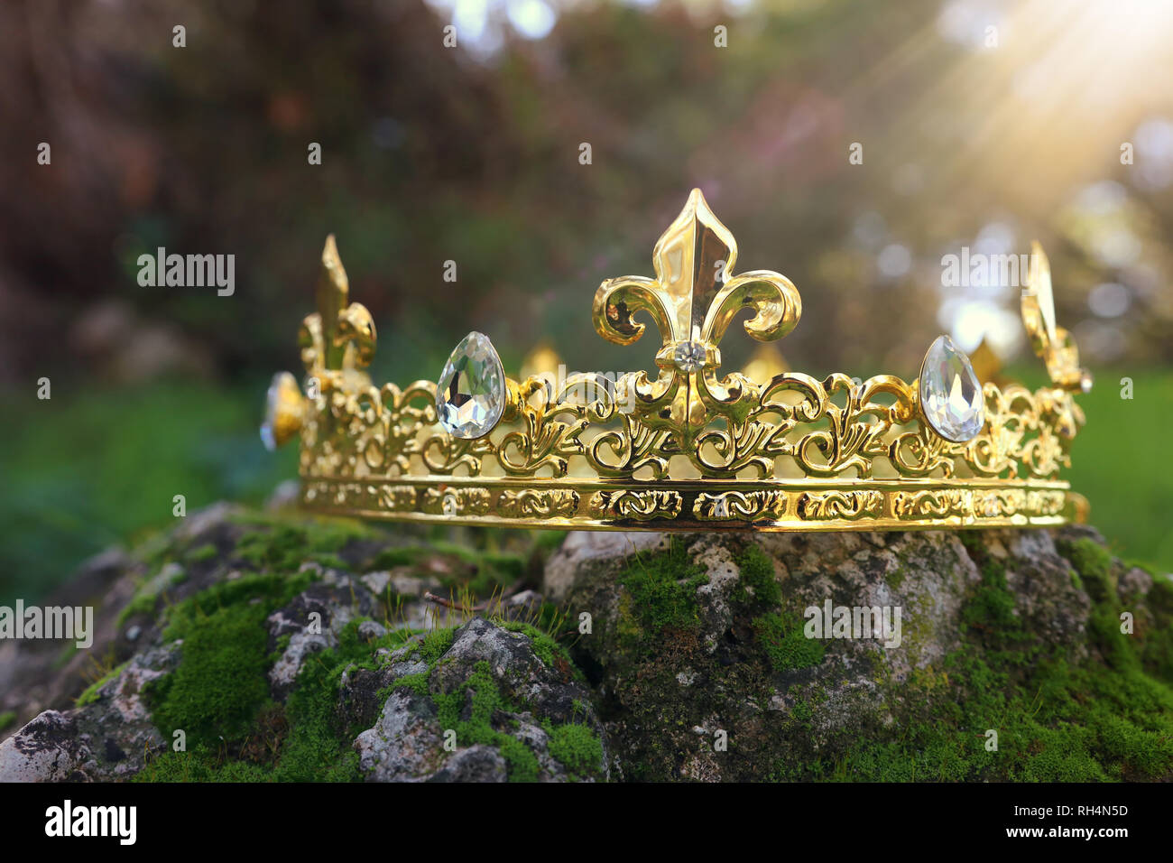 mysterious and magical photo of gold king crown over the stone covered ...