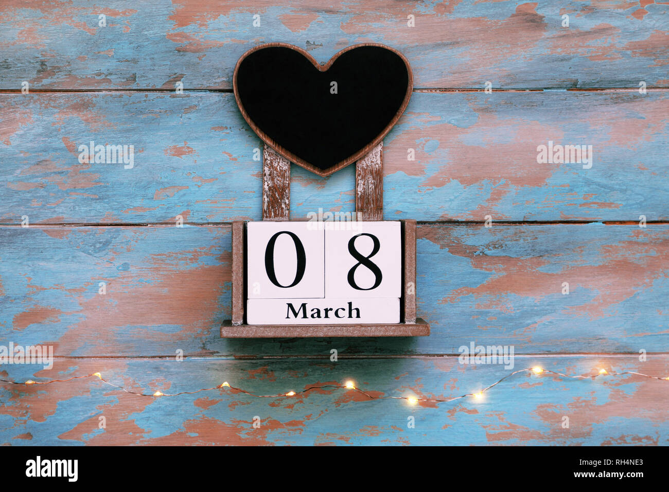 Wooden block save the date calendar, March 8, with heart shaped chalk ...