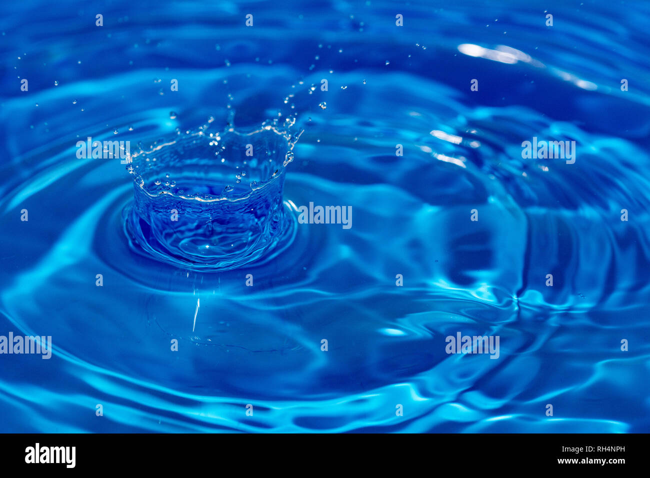 Water drop falling and drips on mirror. Water drop splash and make ...