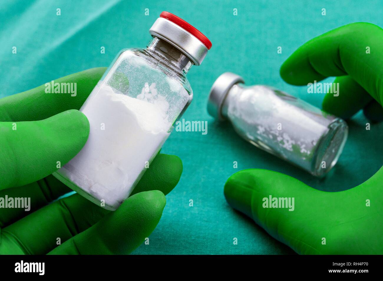 Detail of hand medical holding a vial, conceptual image Stock Photo - Alamy