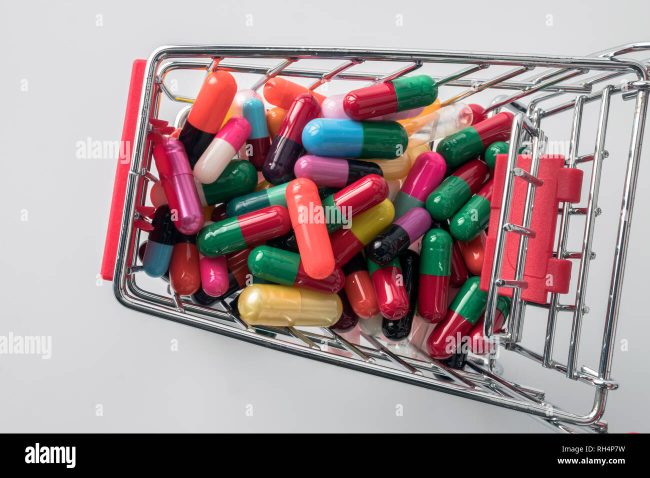 Shopping cart with capsules isolated on white background, composition ...