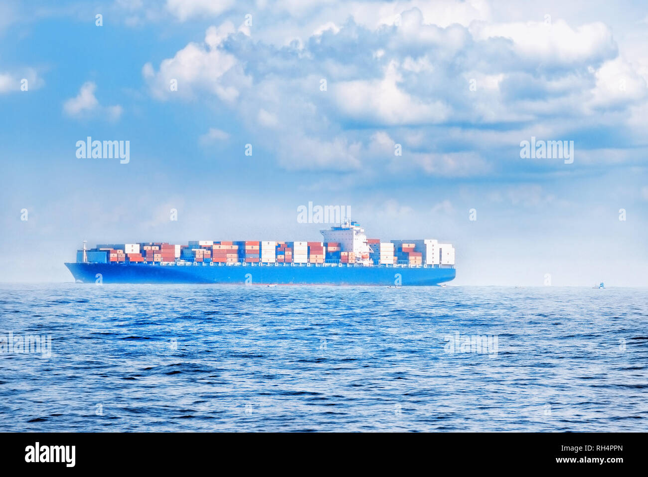 Large container cargo ship in the ocean, side view. For logistics and ...