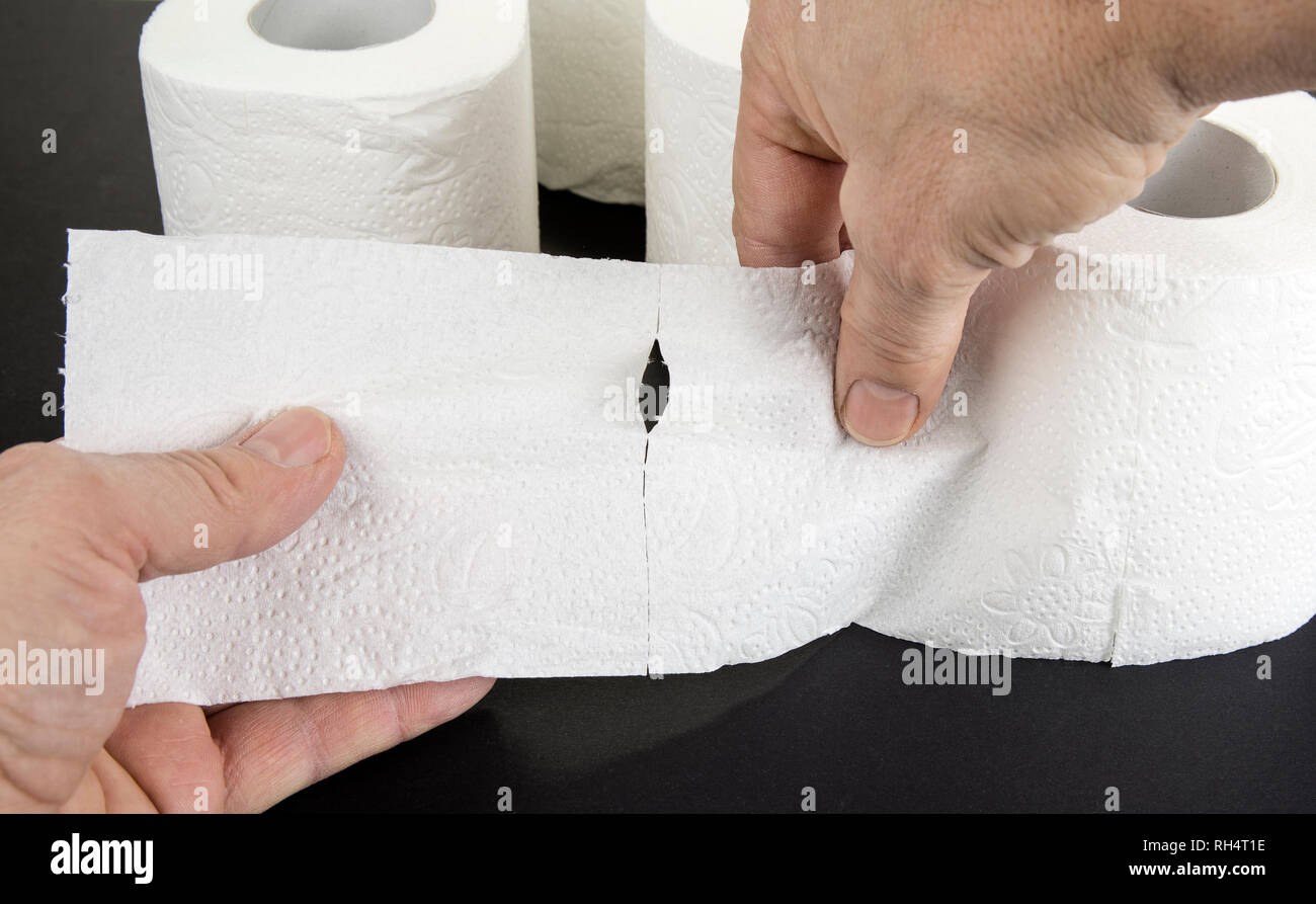 Two hands tear up toilet paper Stock Photo - Alamy