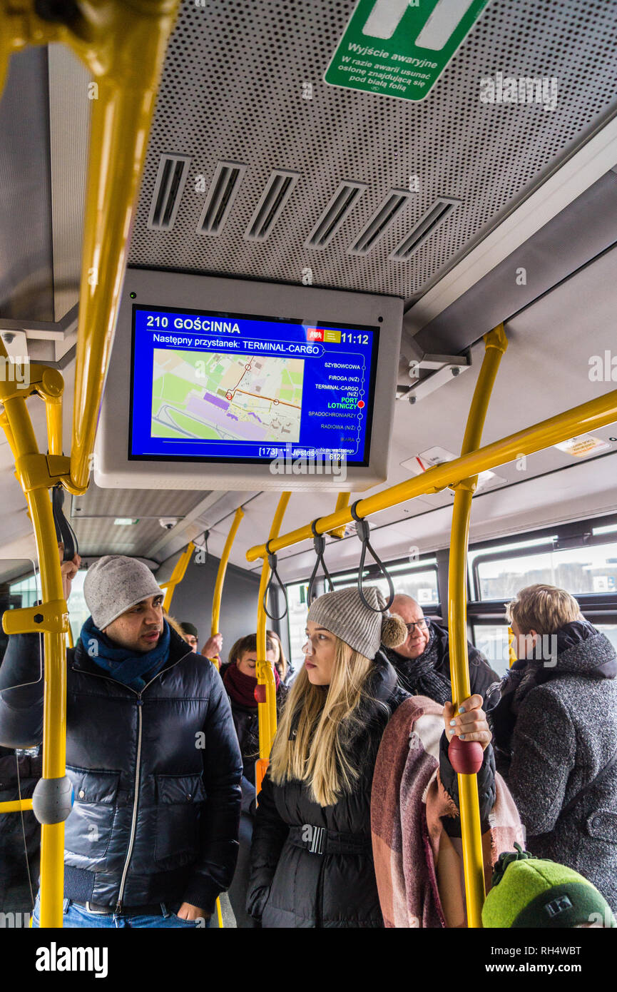 Electronic destination board and passengers on a city bus from the ...