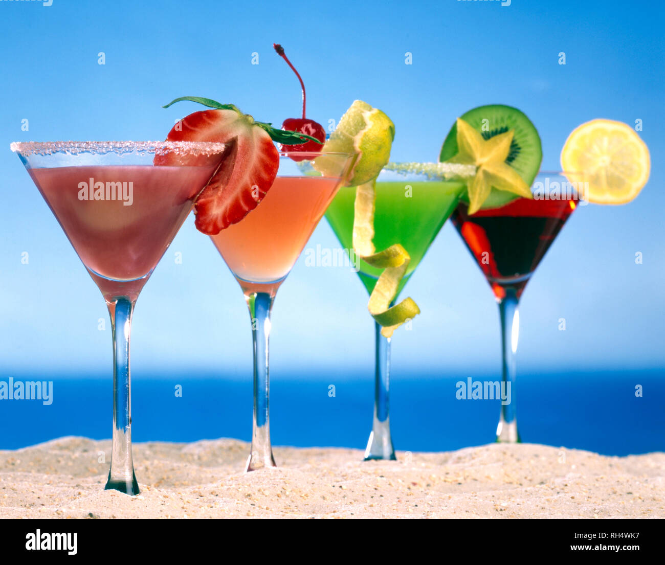 Various colored cocktails in the sand on the beach Stock Photo - Alamy