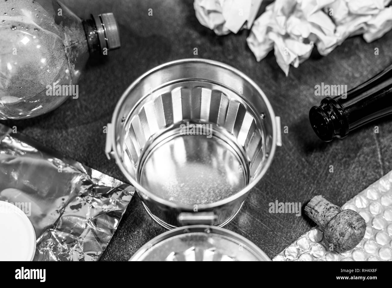 open empty garbage bin surrounded by reusable waste materials like ...