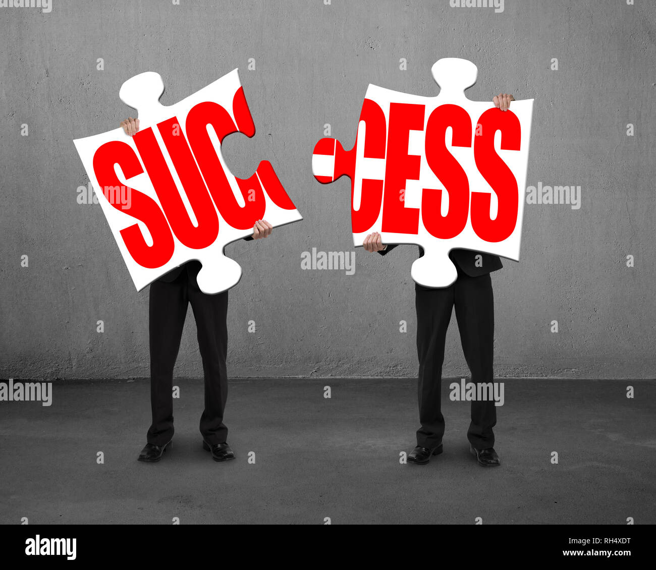 Connecting two puzzles for success concrete background Stock Photo - Alamy