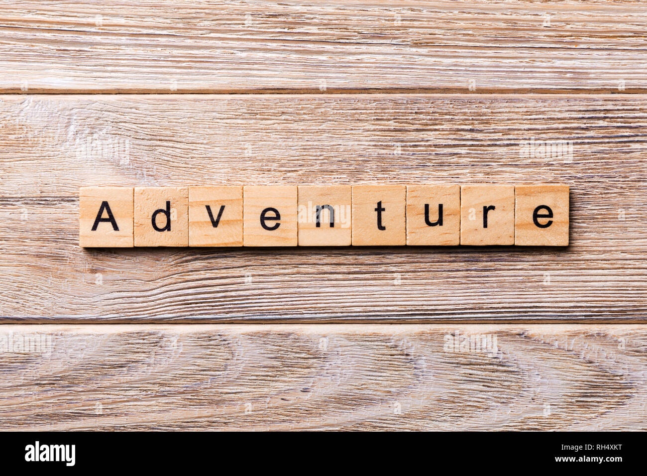 adventure word written on wood block. adventure text on wooden table ...