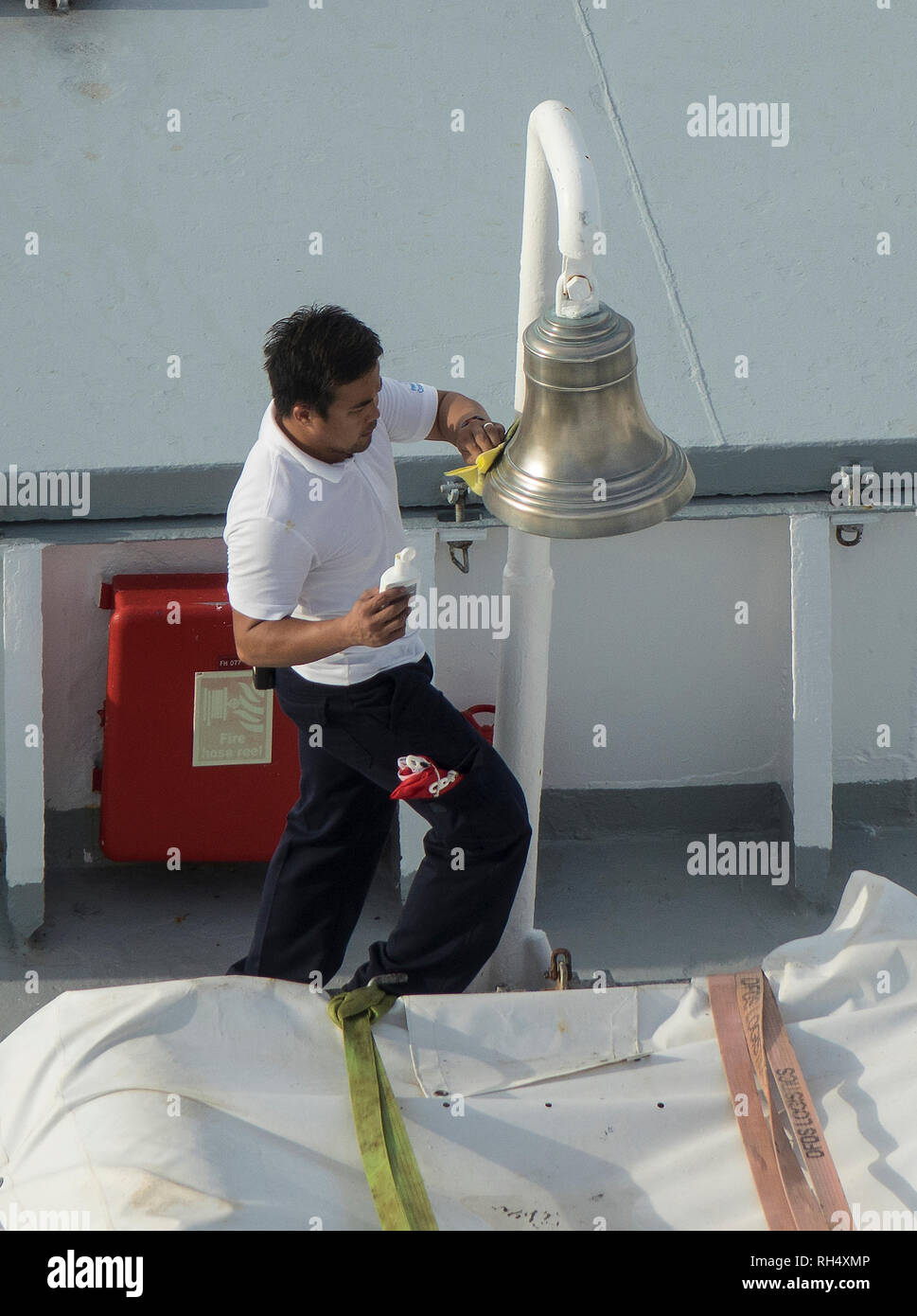 Crew polishing ship's bell Stock Photo - Alamy