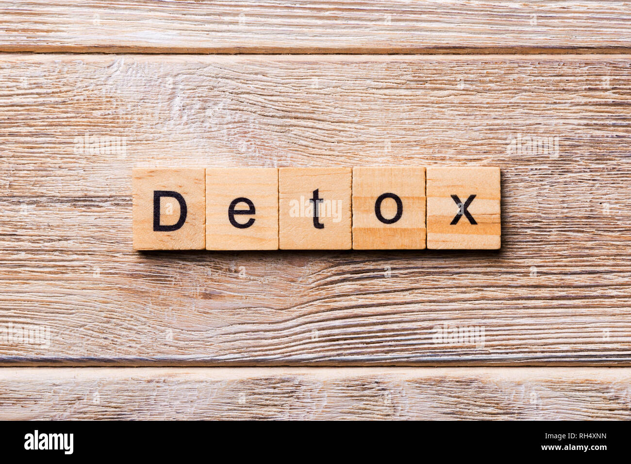 detox word written on wood block. detox text on wooden table for your ...