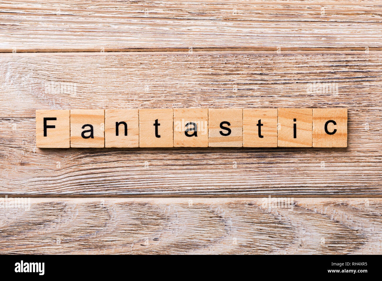 fantastic word written on wood block. fantastic text on wooden table ...