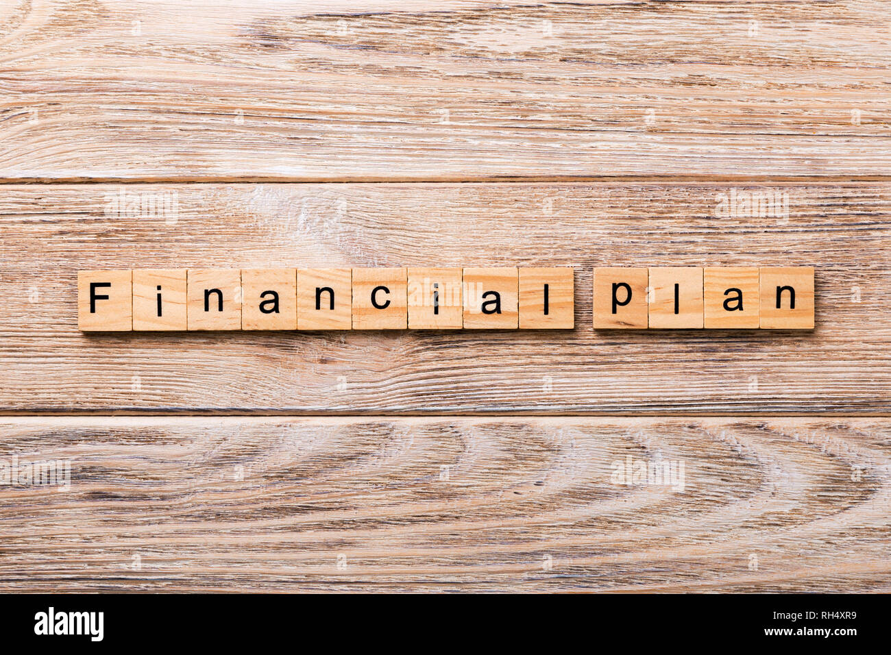 financial plan word written on wood block. financial plan text on ...
