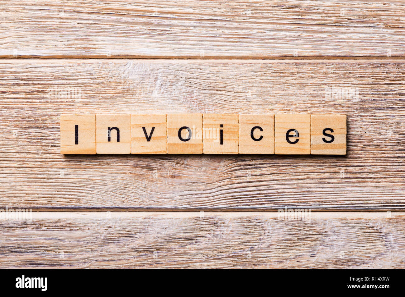 INVOICES word written on wood block. INVOICES text on wooden table for ...