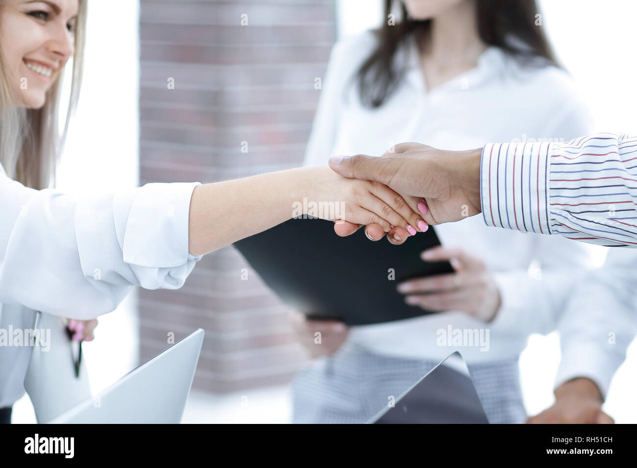 closeup.handshake business colleagues on the background of the office ...