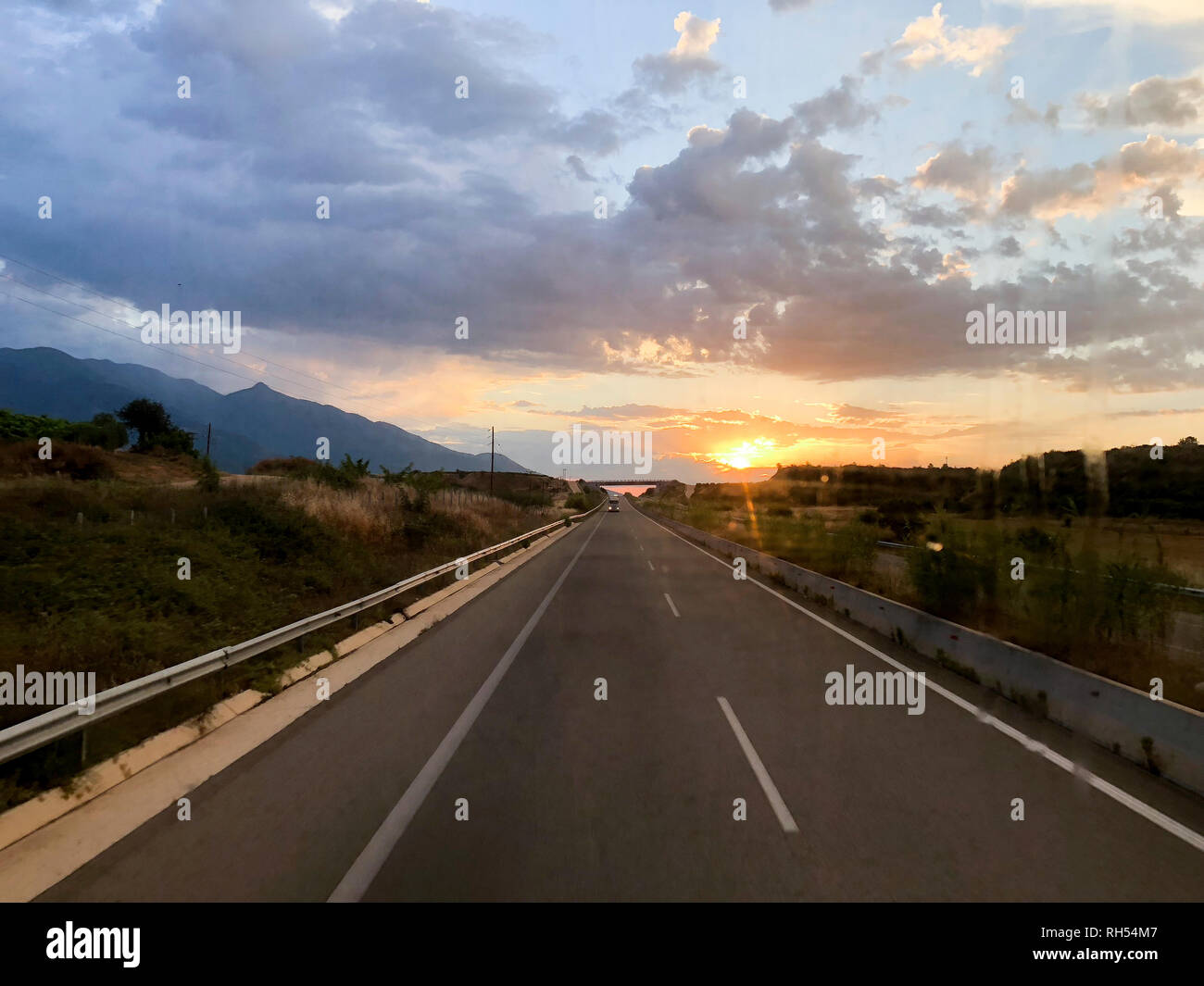 Road view in the evening with a sunset Stock Photo - Alamy