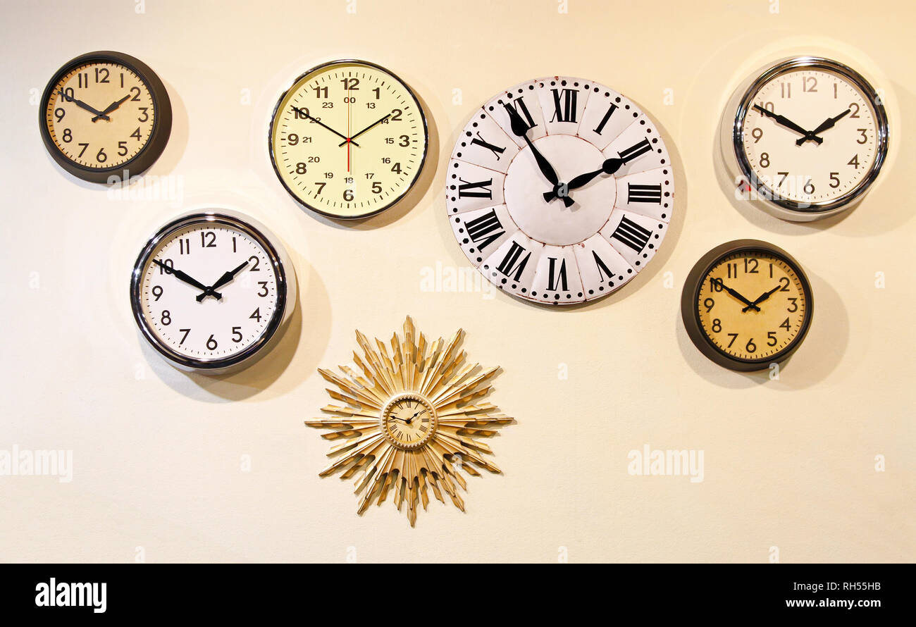 Seven different styles analog clocks on wall Stock Photo - Alamy
