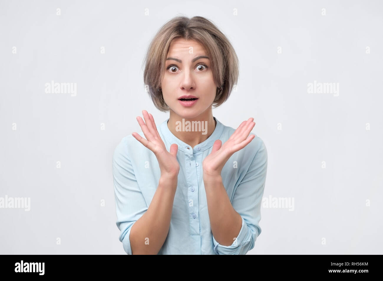 Shocked excited young lady standing isolated over white background ...