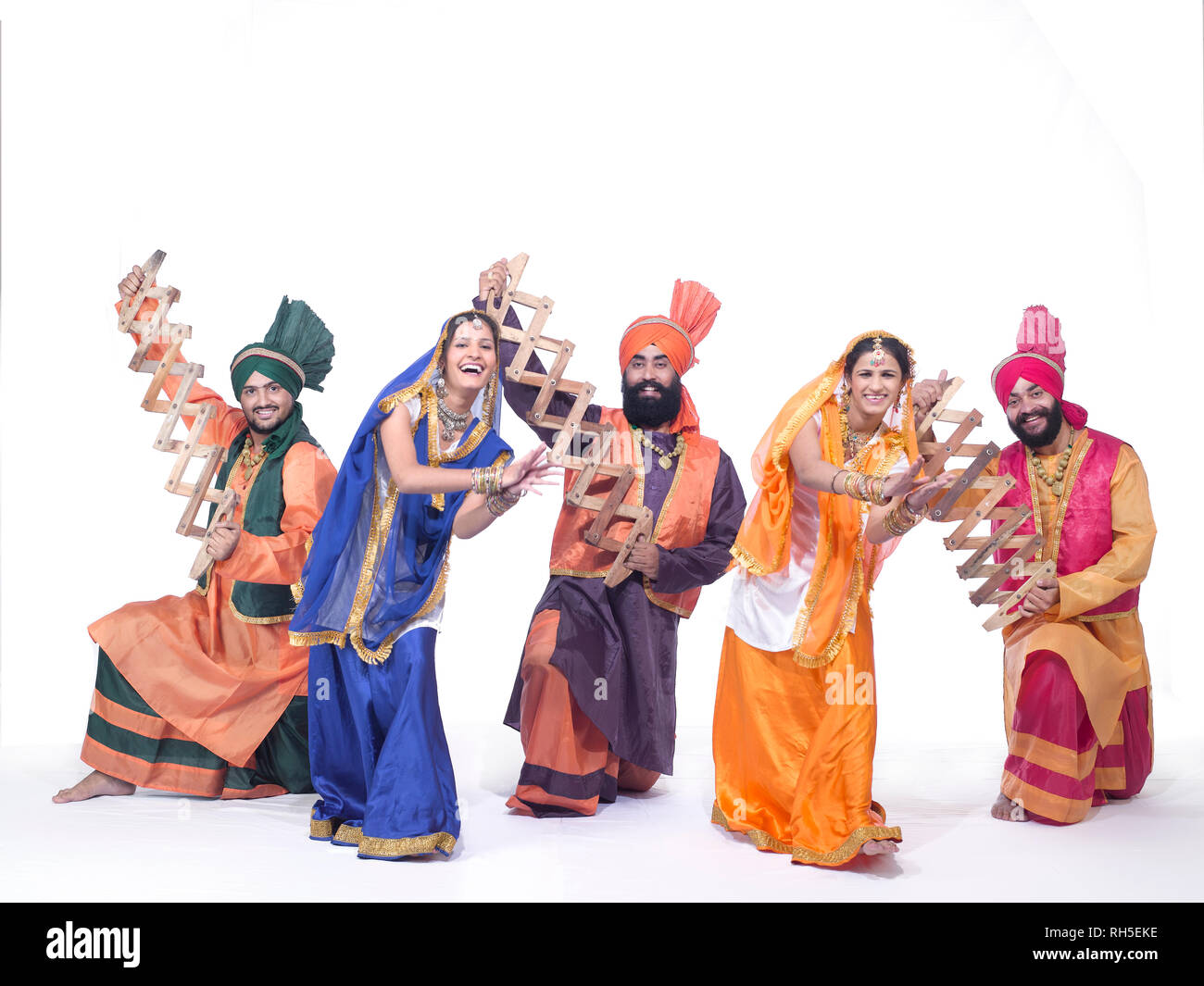 PORTRAIT OF A GROUP OF BHANGRA DANCERS DANCING WITH THE WOODEN SNAKE ...