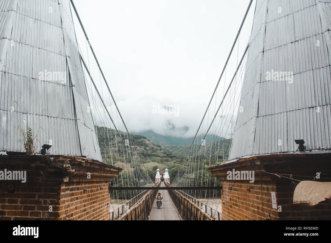 Colombian locals ride a motorbike across the famous Puente del ...