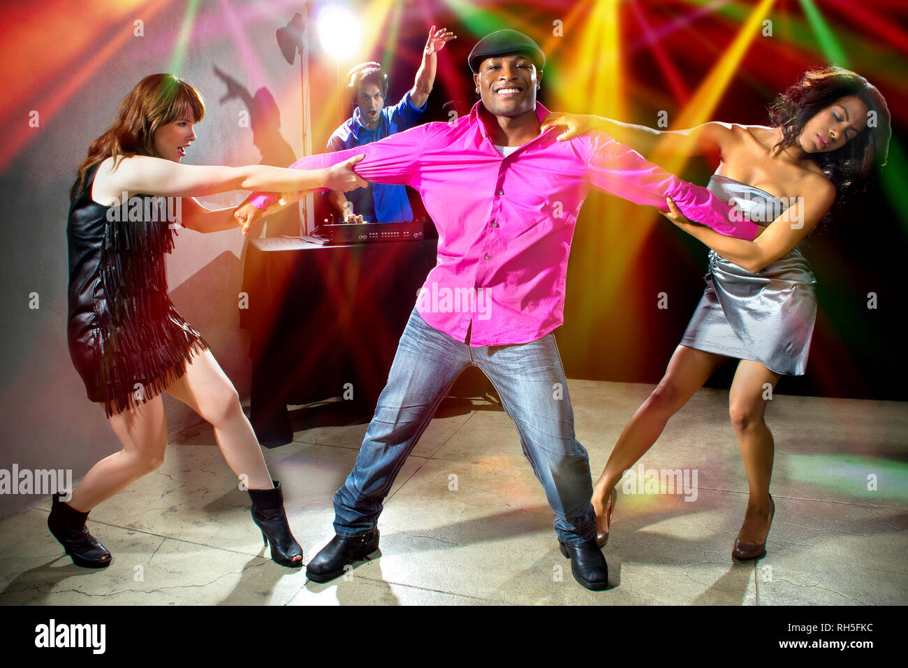 female rivals pulling and grabbing a man in a nightclub Stock Photo - Alamy