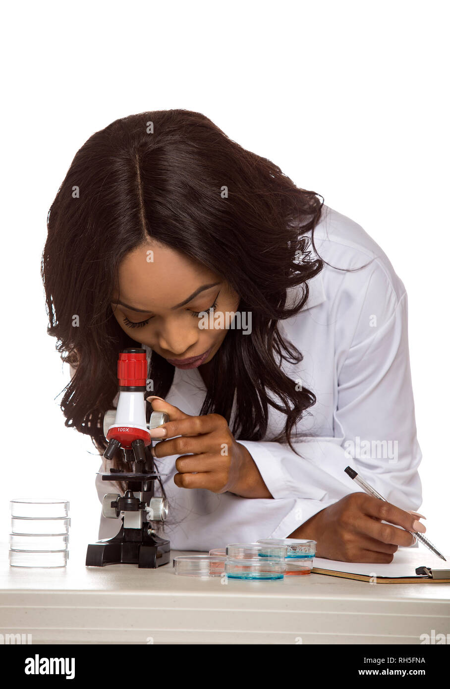 Black female scientist wearing a lab coat with microscope and petri ...