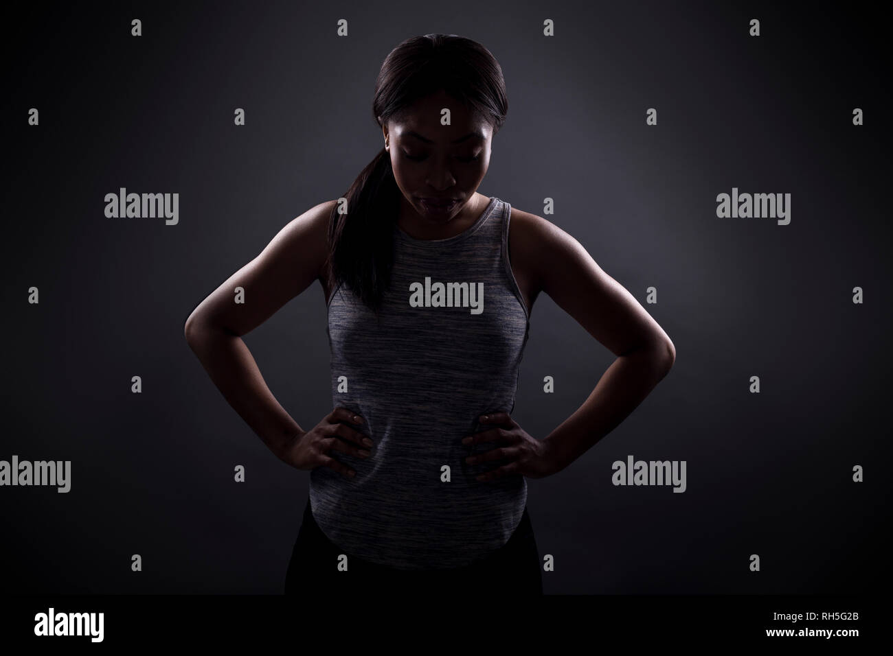 Silhouette of black female in an angry pose or portrait of an athlete ...