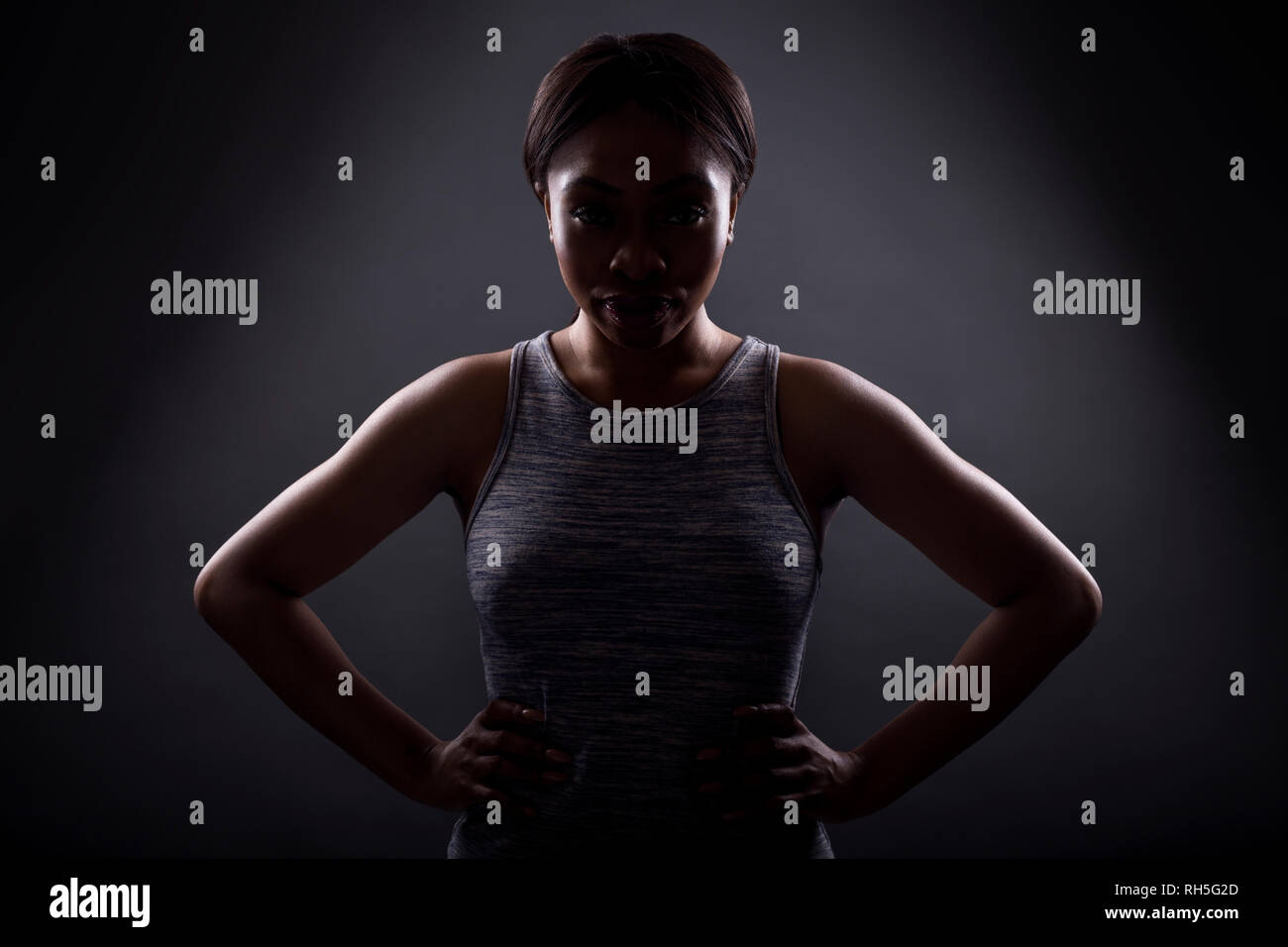 Silhouette of black female in an angry pose or portrait of an athlete ...