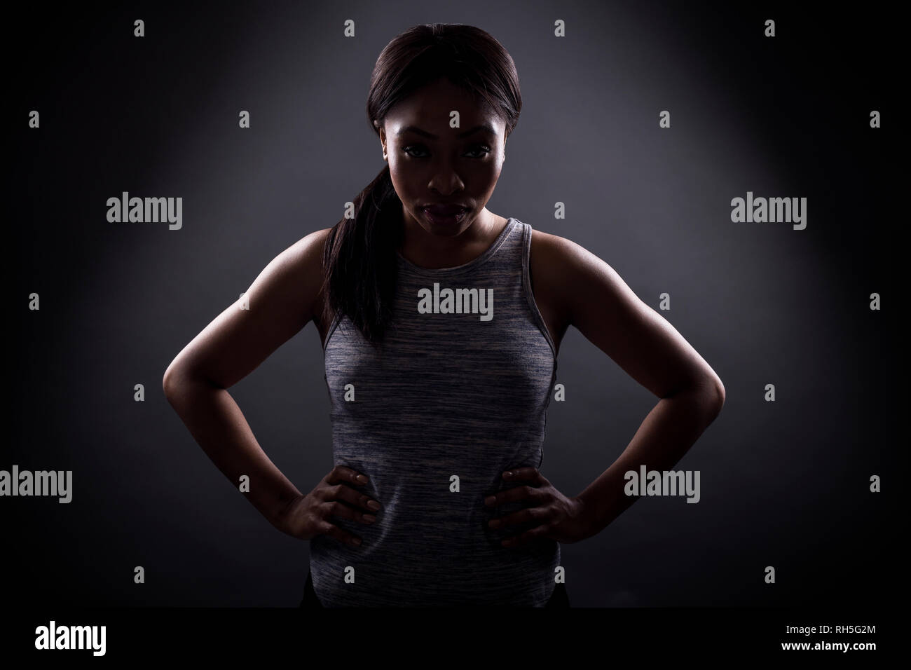 Silhouette of black female in an angry pose or portrait of an athlete ...