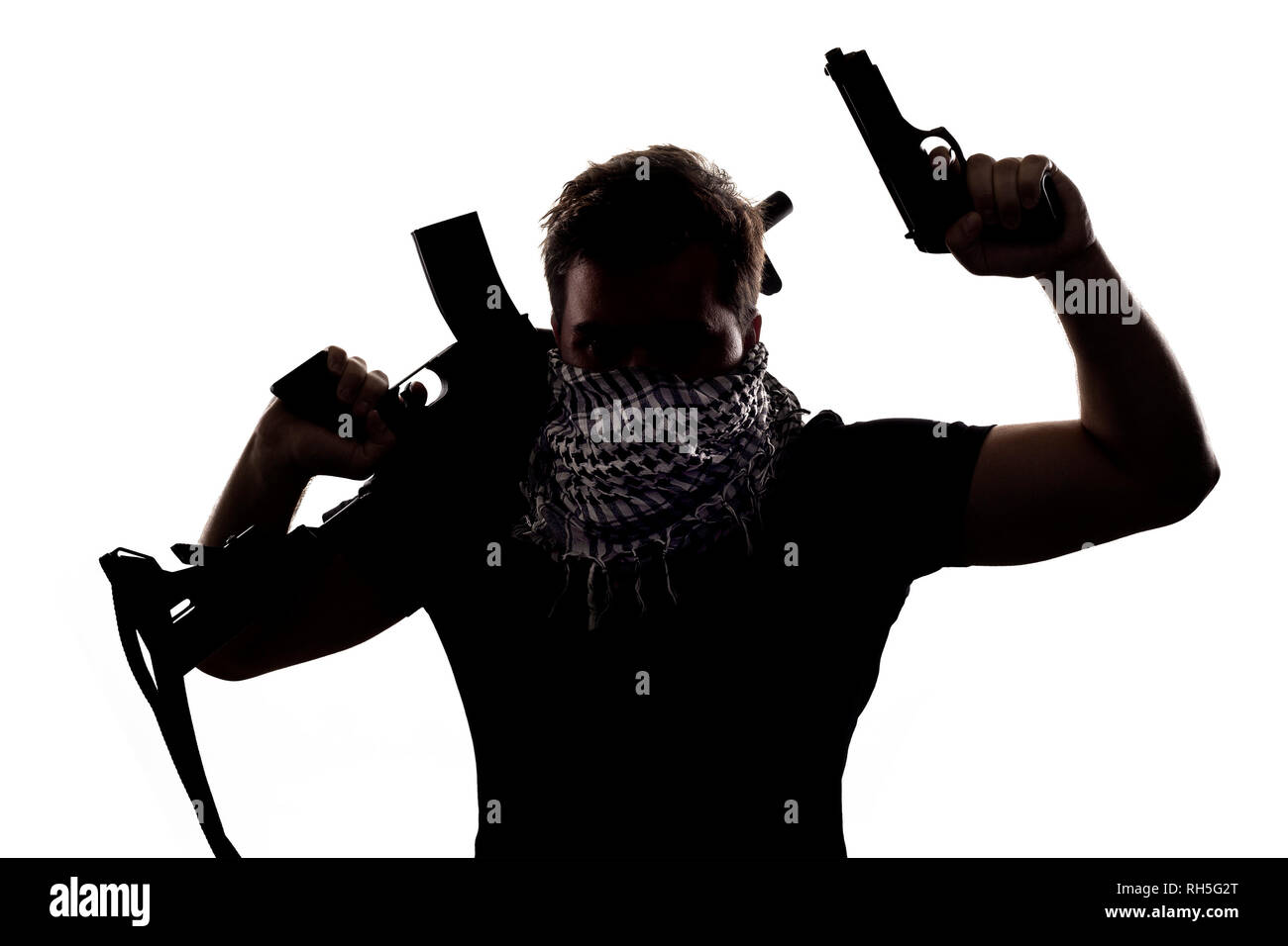 Ambiguous silhouette of a terrorist or a soldier with a rifle and a ...