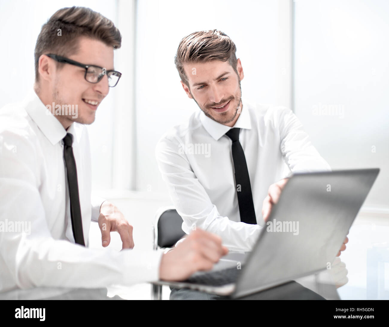 young people in the office working with a laptop Stock Photo - Alamy