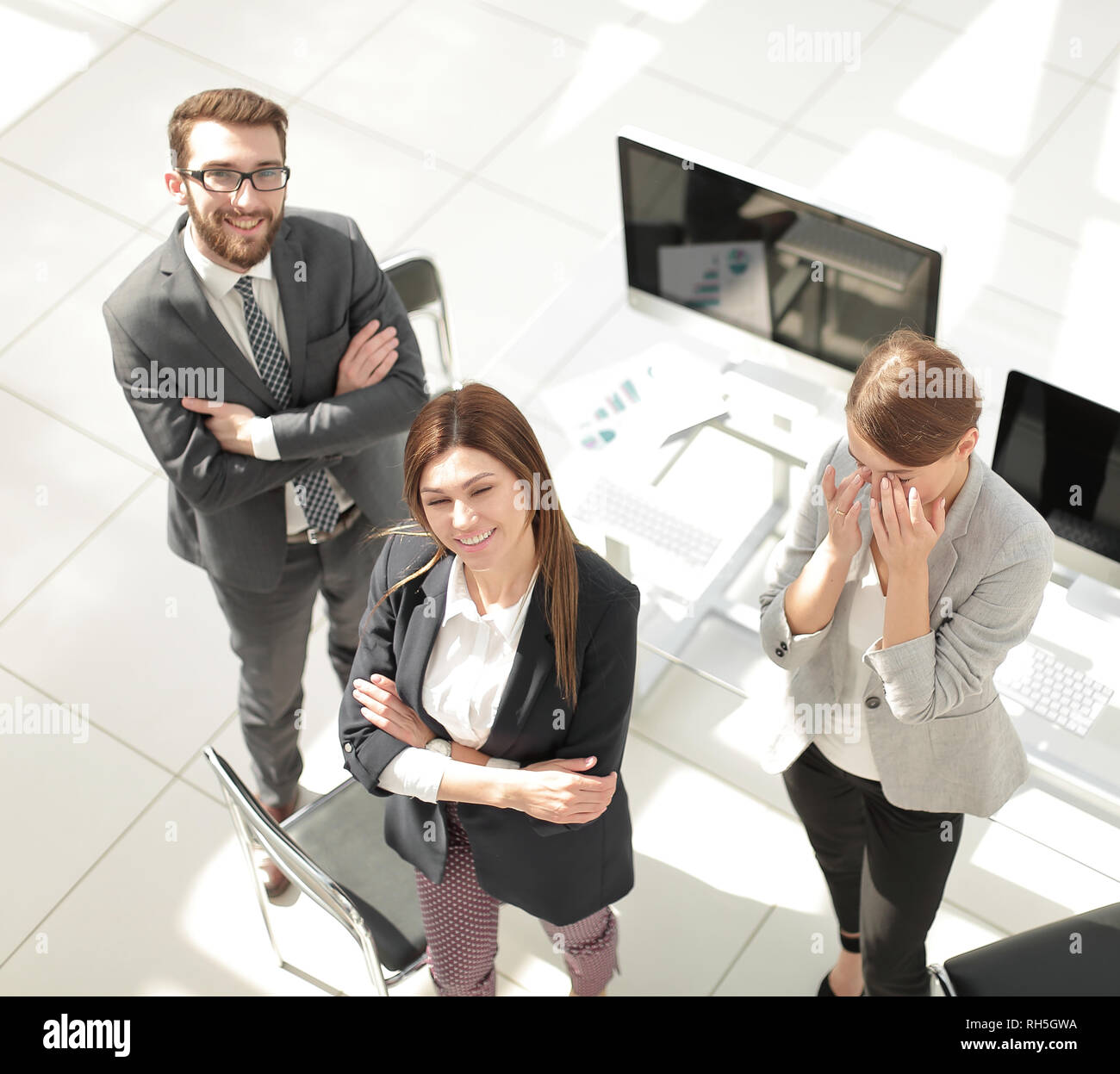 top view. three employees standing in the office Stock Photo - Alamy