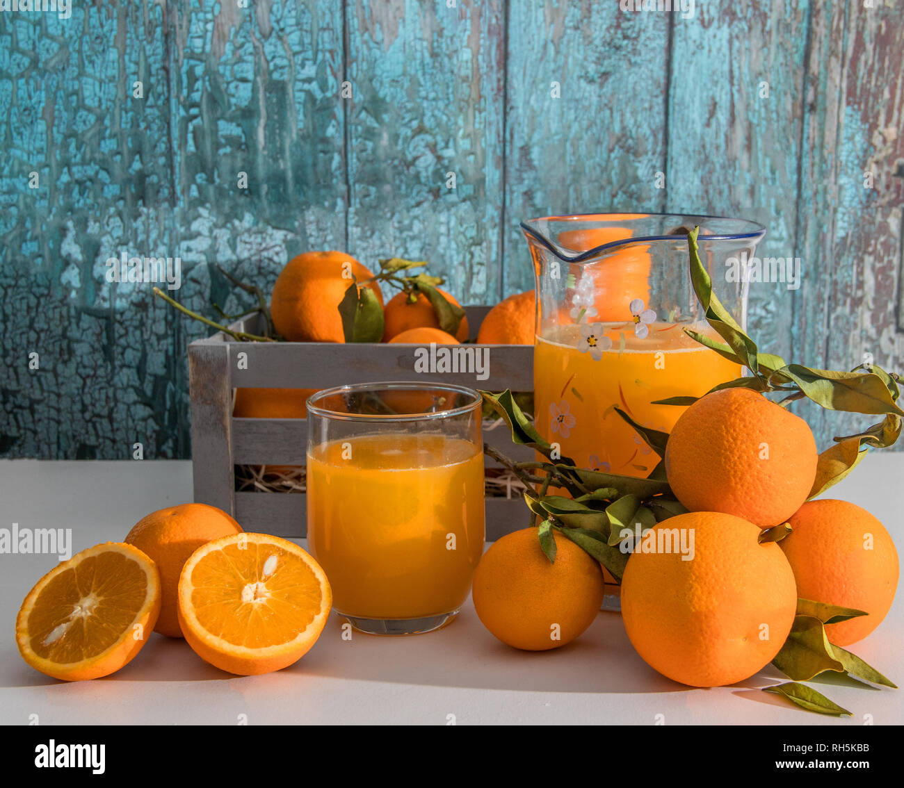 orange split in half with a glass and a jug of orange juice Stock Photo ...