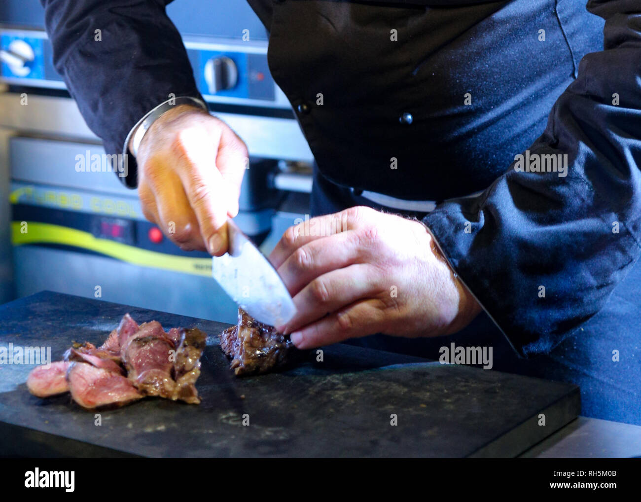 Butcher cutting pork meat, Chef cutting fresh raw meat, Chef cooking ...