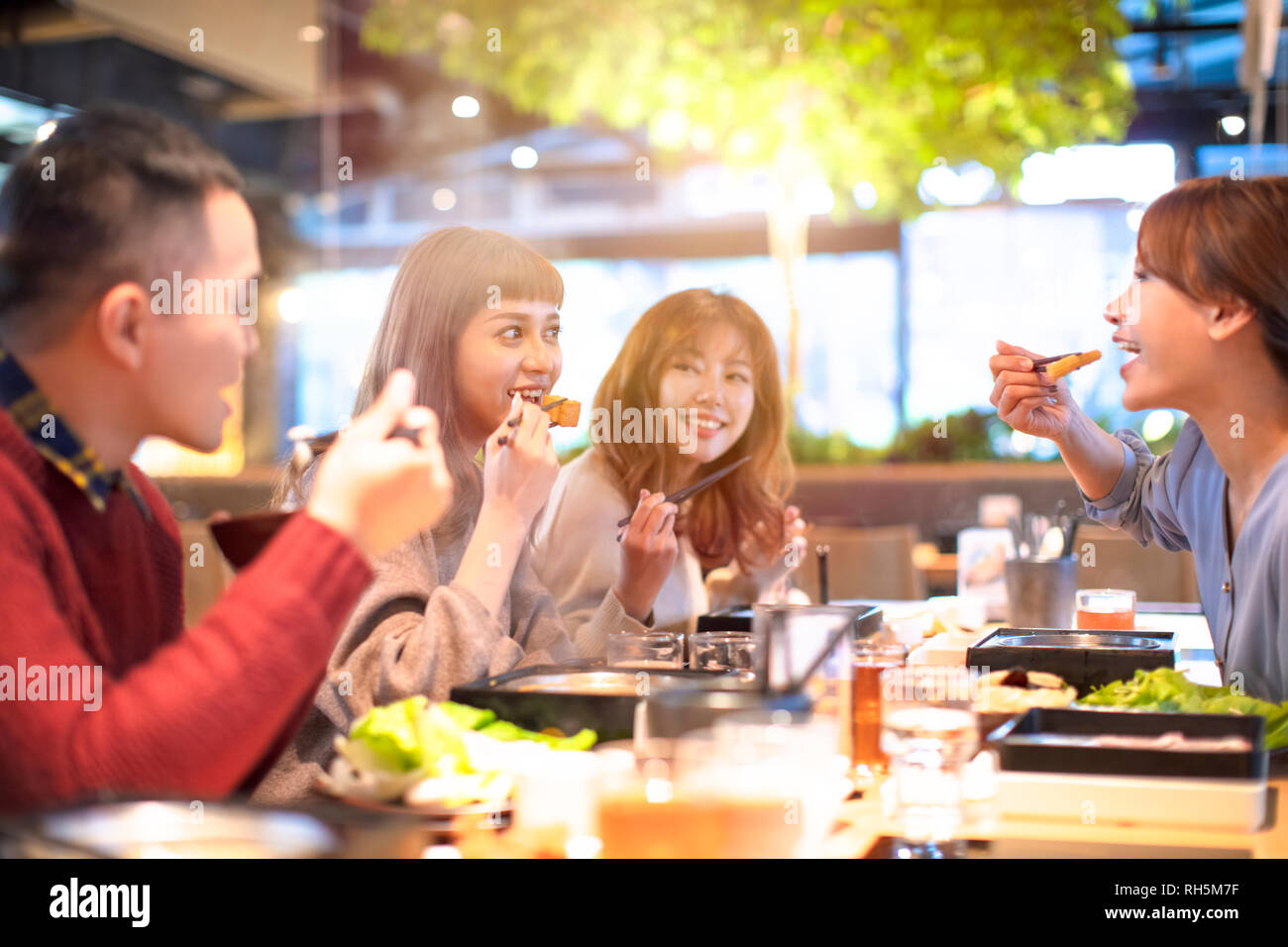 happy asian young Group eating in the restaurant Stock Photo - Alamy