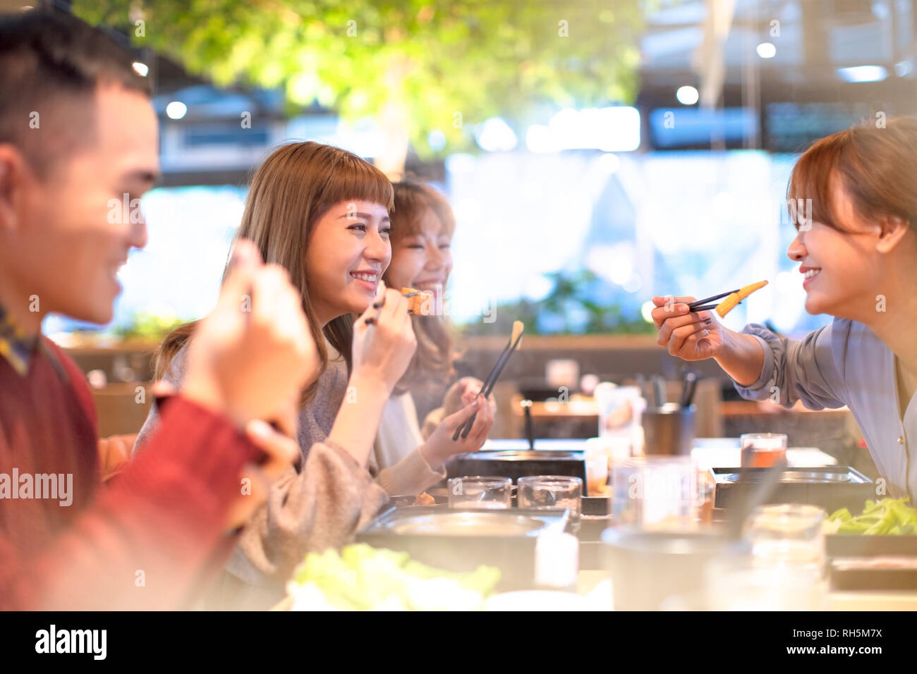 young friends eating hot pot in the restaurant Stock Photo - Alamy