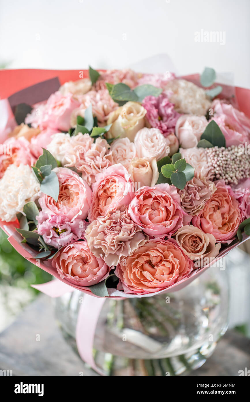 beautiful fresh cut bouquet of mixed flowers in vase on wooden table ...