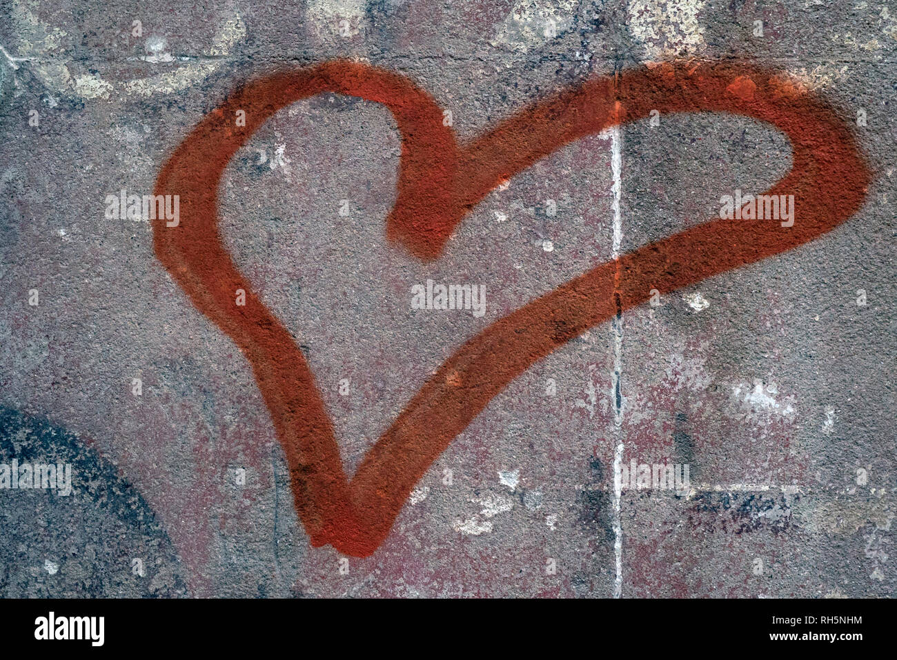 A Red Spray Painted Graffiti Heart On A Distressed Stone Wall Stock ...