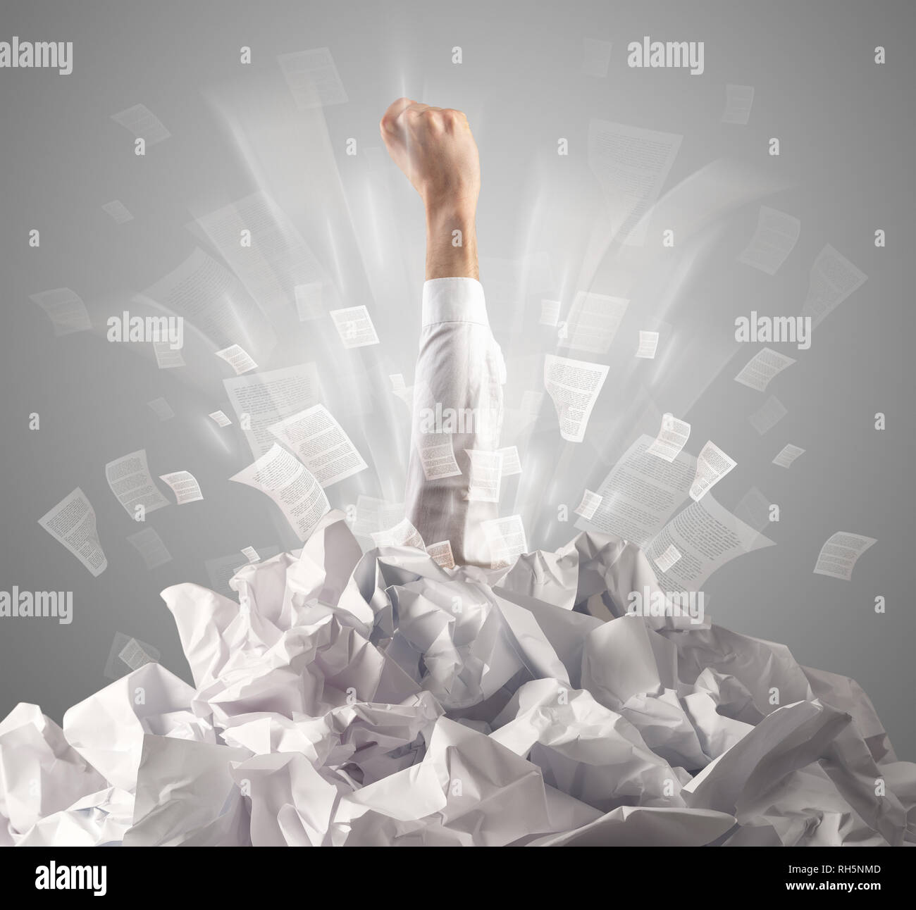 Hand coming out from a huge paper pile Stock Photo - Alamy